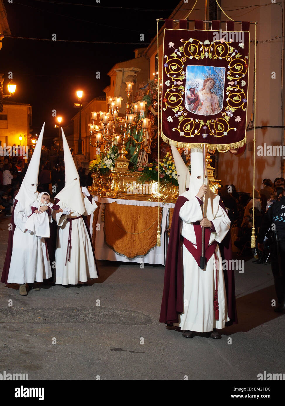 Nazarenos (penitents) walking in a night time procession during Semana ...