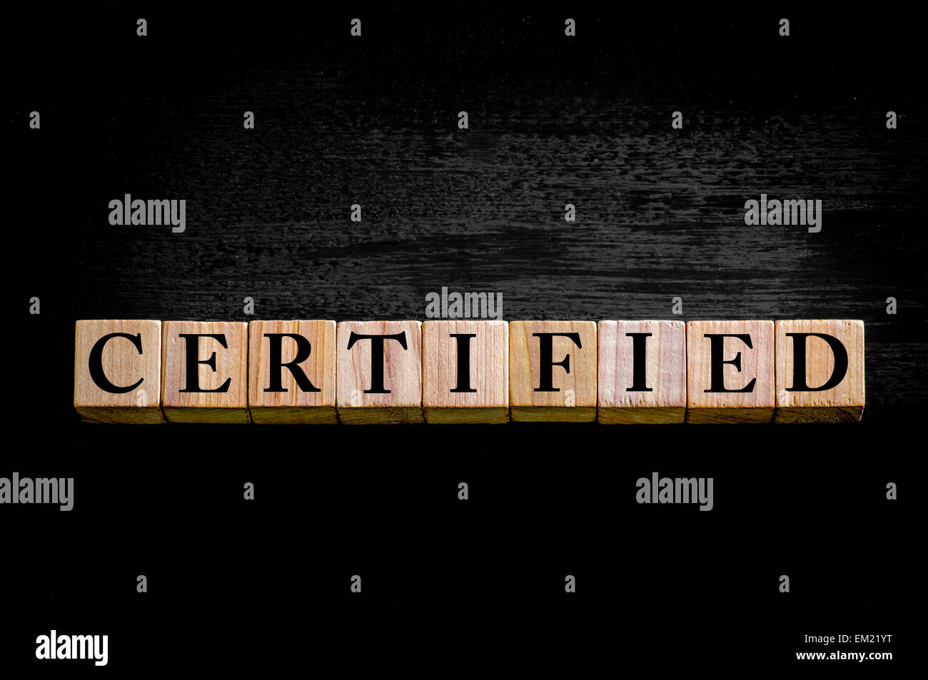 Word CERTIFIED. Wooden small cubes with letters isolated on black ...