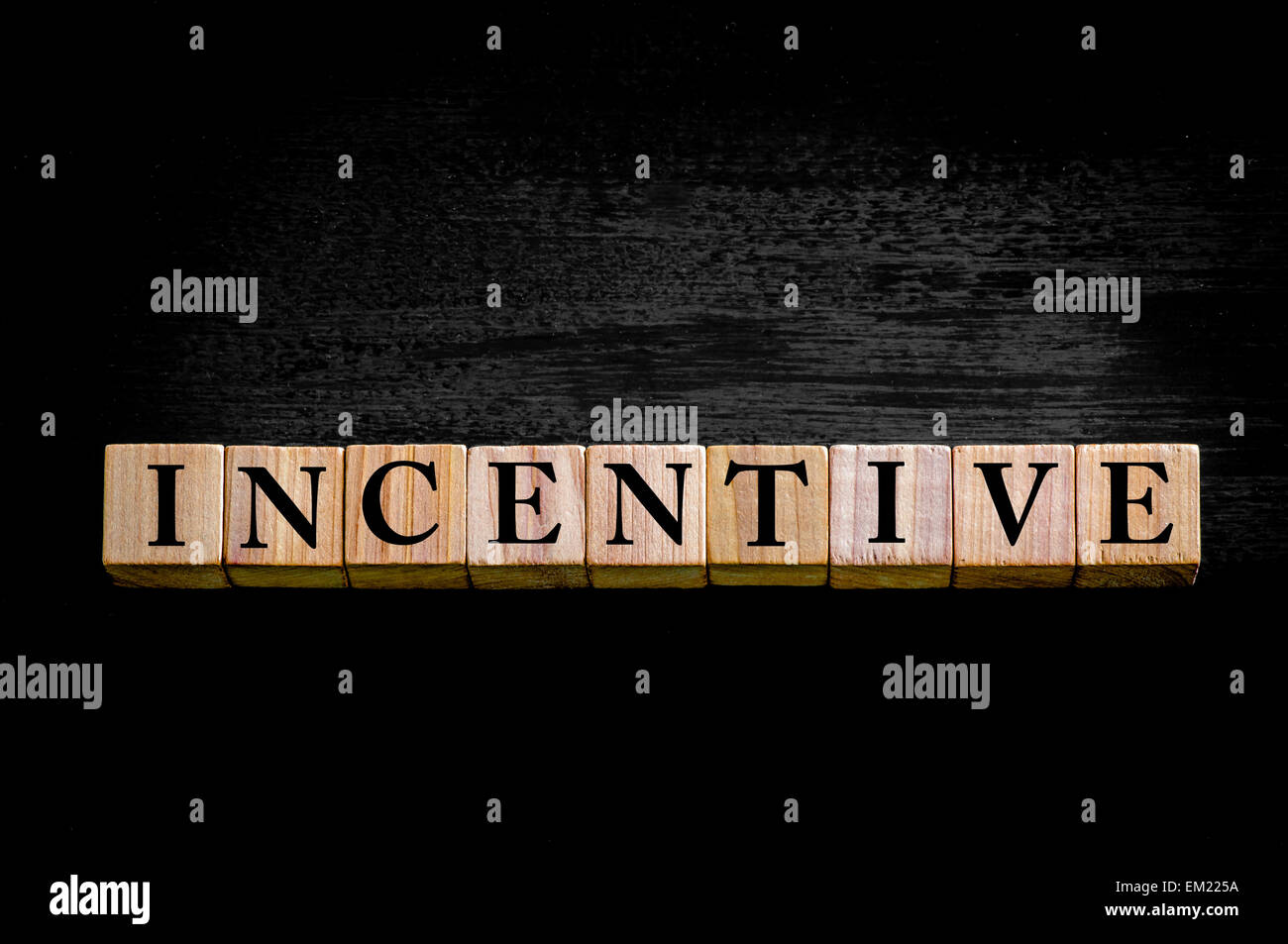 Word INCENTIVE. Wooden small cubes with letters isolated on black ...