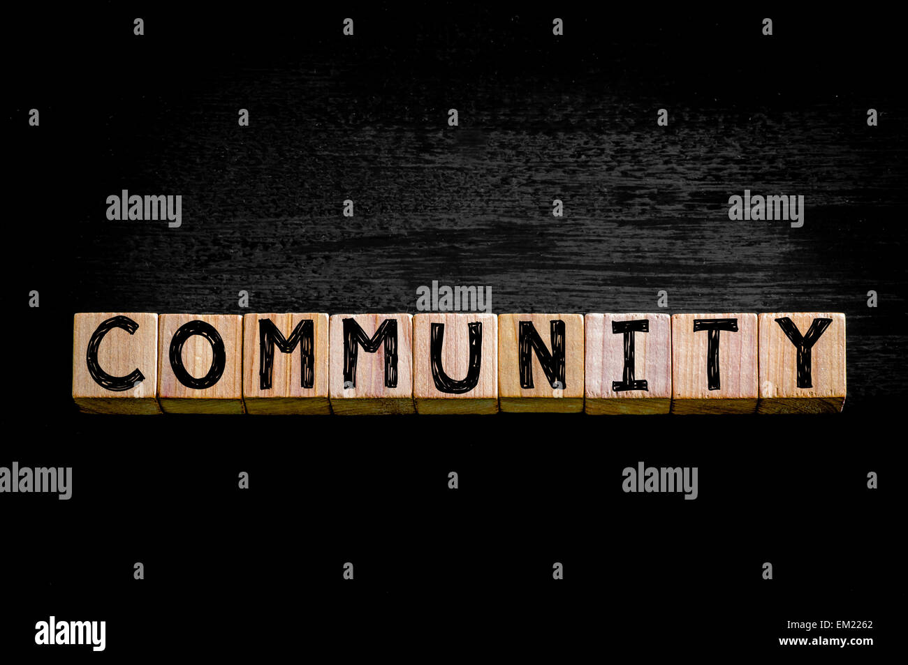 Word COMMUNITY. Wooden small cubes with letters isolated on black ...