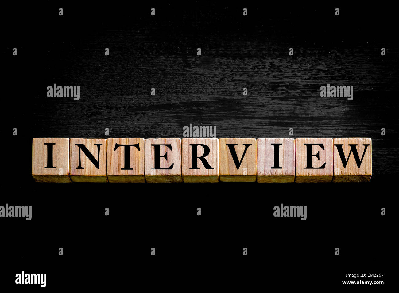 Word INTERVIEW. Wooden small cubes with letters isolated on black ...