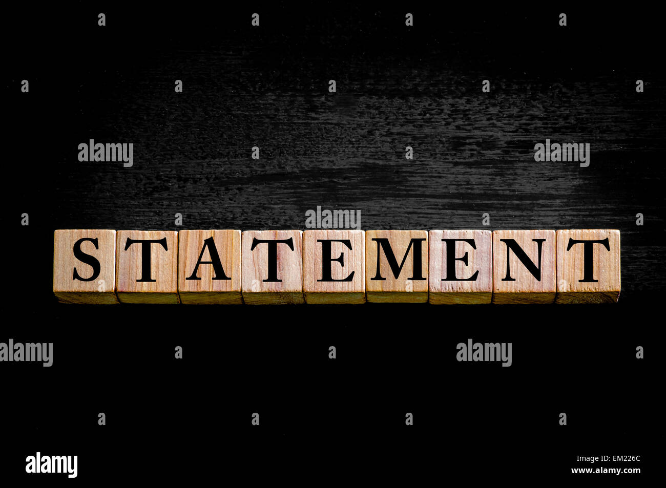 Word STATEMENT. Wooden small cubes with letters isolated on black ...