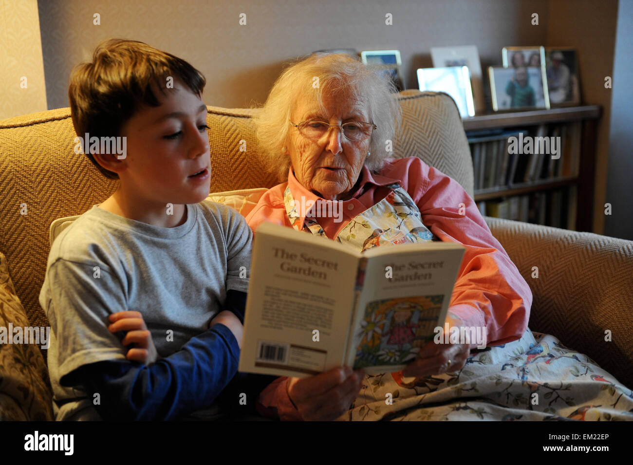 Grandparent listening to her grandson reading The Secret Garden Stock ...