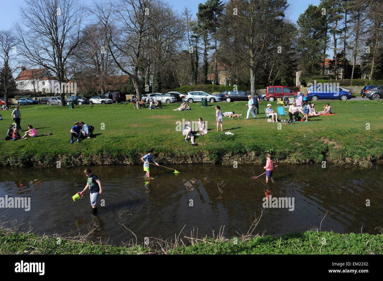 Families paddling and fishing in The River Leven in Great Ayton, North ...