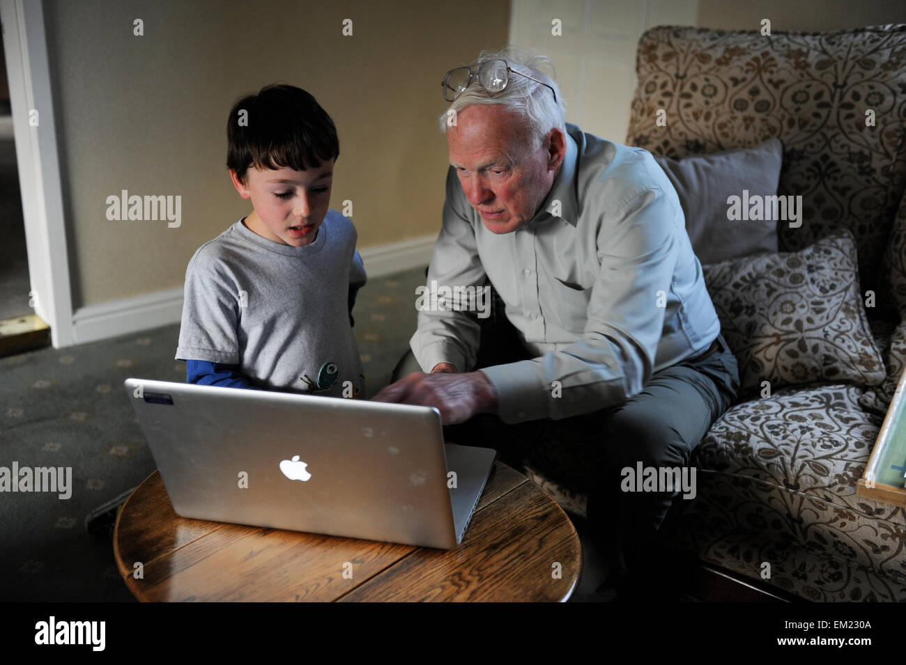 Grandfather and grandson using laptop at home Stock Photo - Alamy