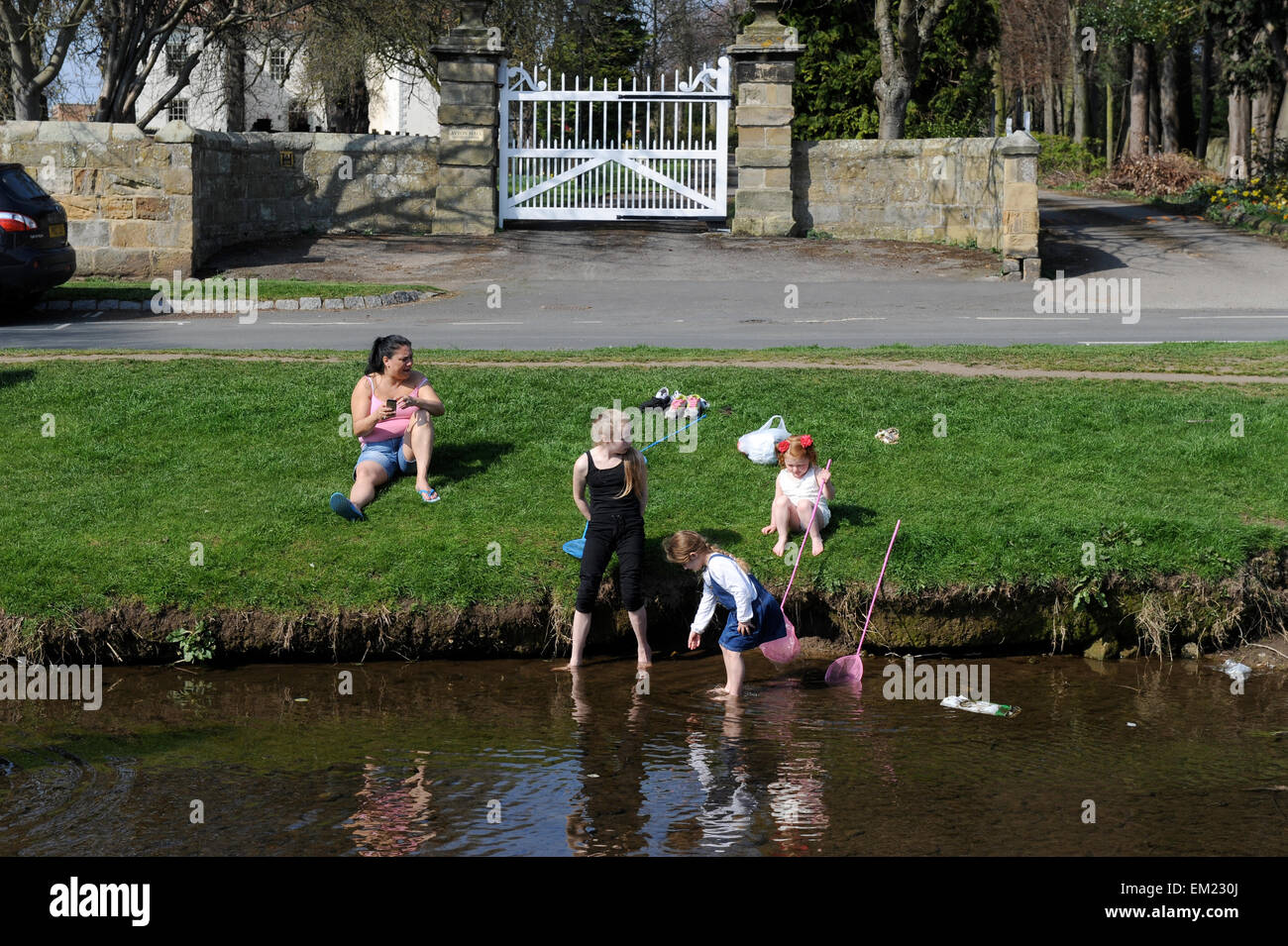 Families paddling and fishing in The River Leven in Great Ayton, North ...