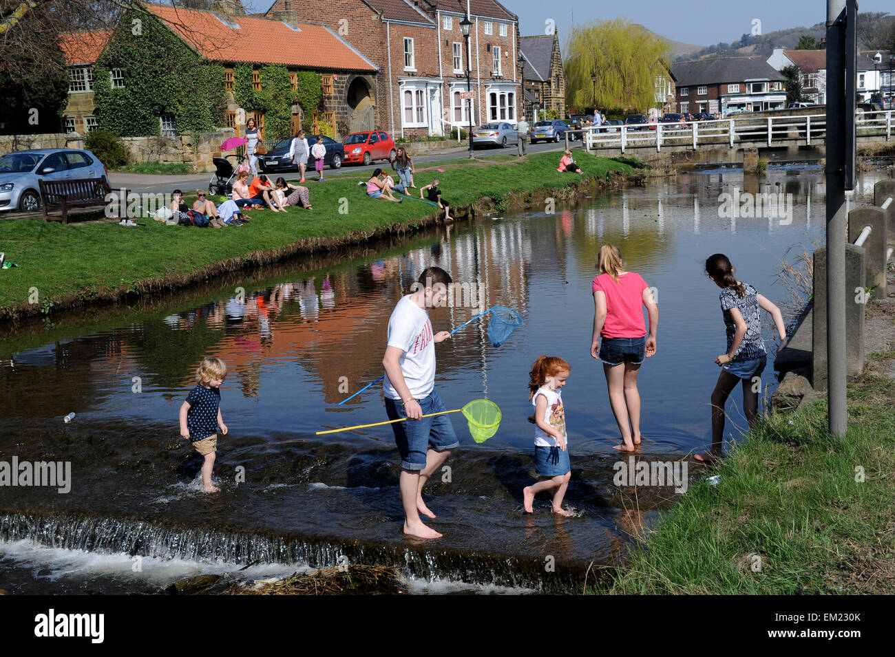 Families paddling and fishing in The River Leven in Great Ayton, North ...