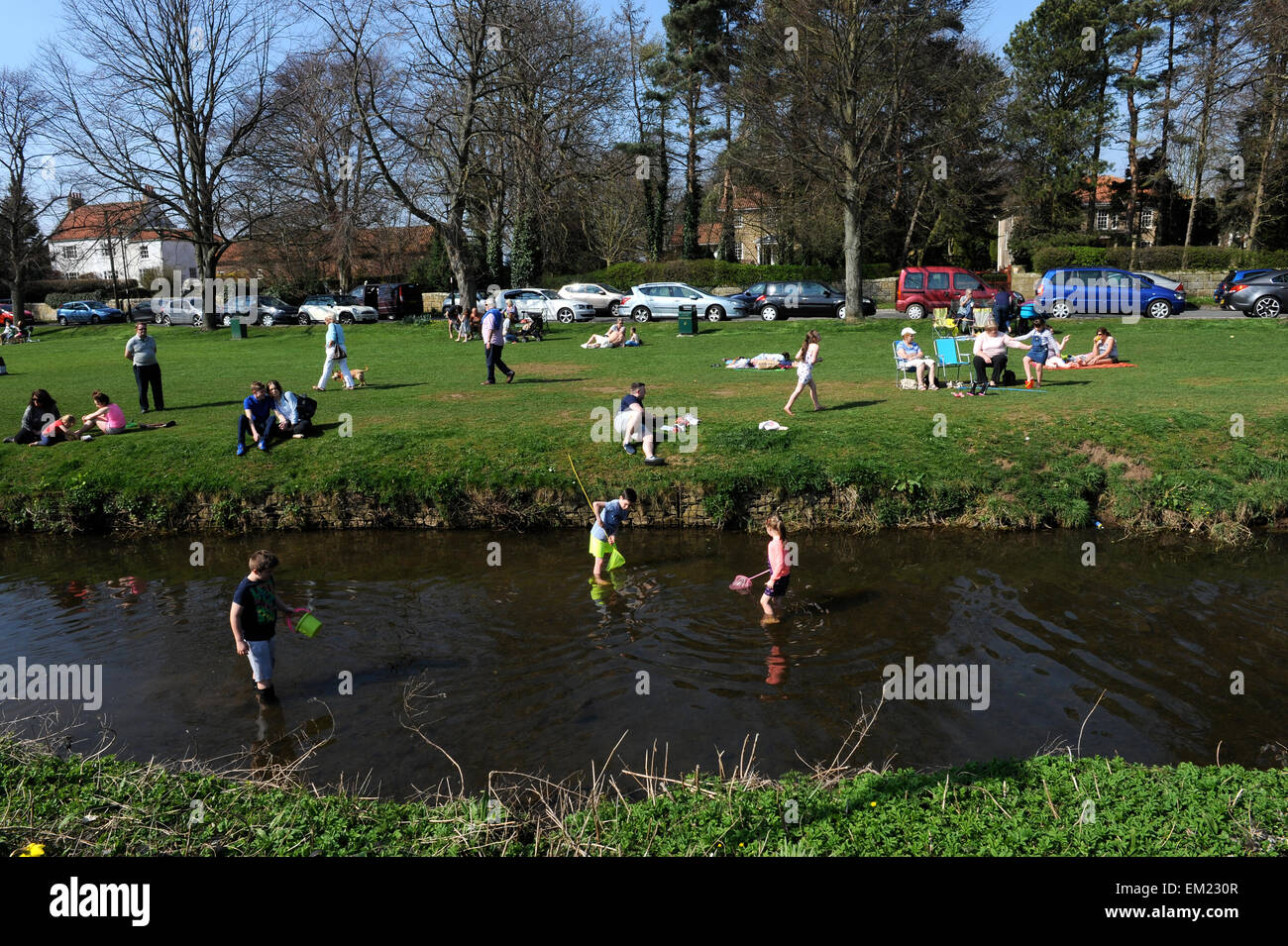 Families paddling and fishing in The River Leven in Great Ayton, North ...