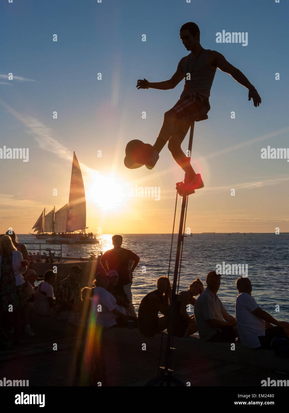 Unicycle riding juggler entertains tourists at Mallory Square during ...