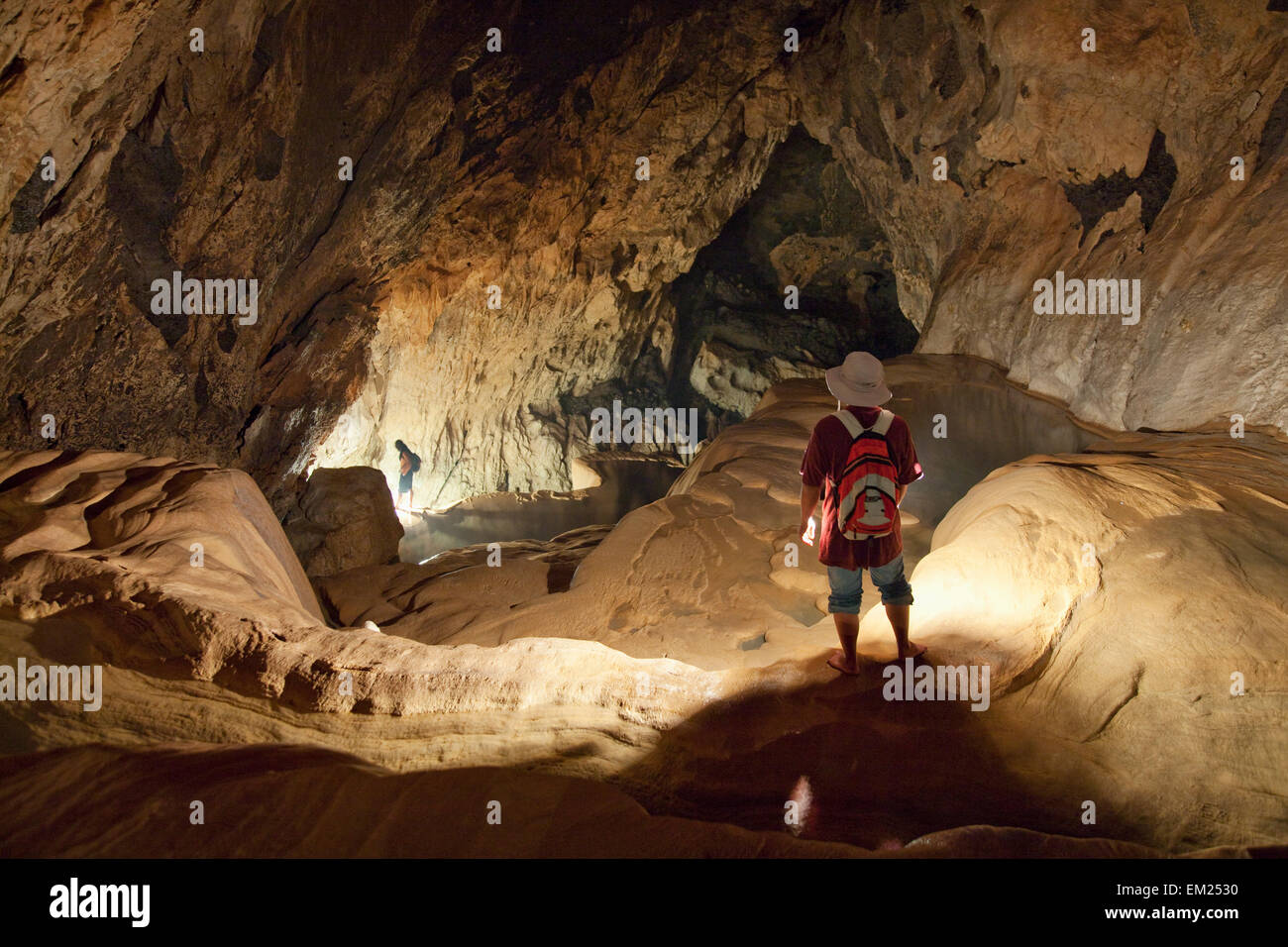 A Filipino Tour Guide Holds A Lantern Inside Sumaging Cave Or Big Cave ...