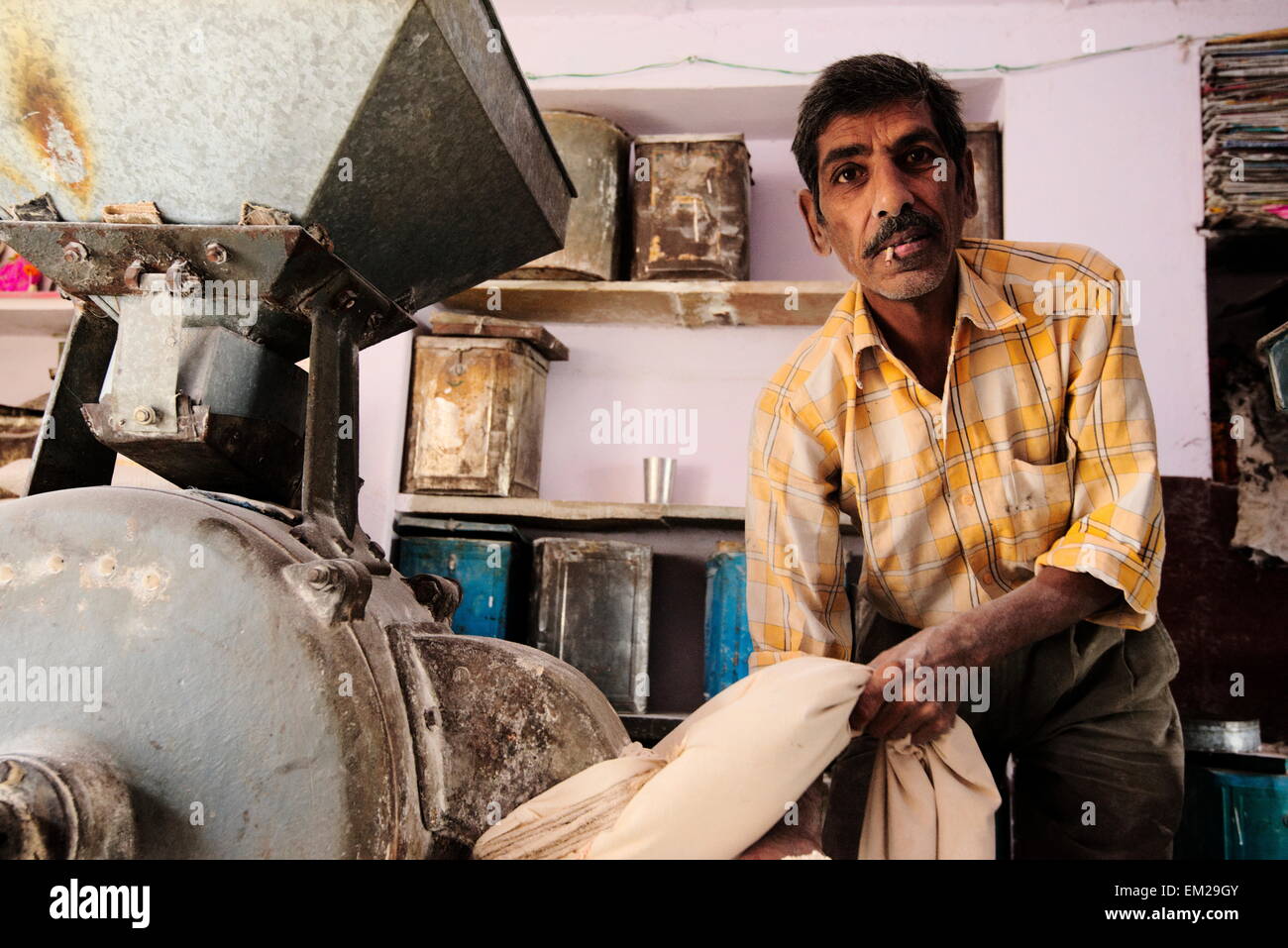 Miller working at a small mill inside Udaipur old town Stock Photo - Alamy