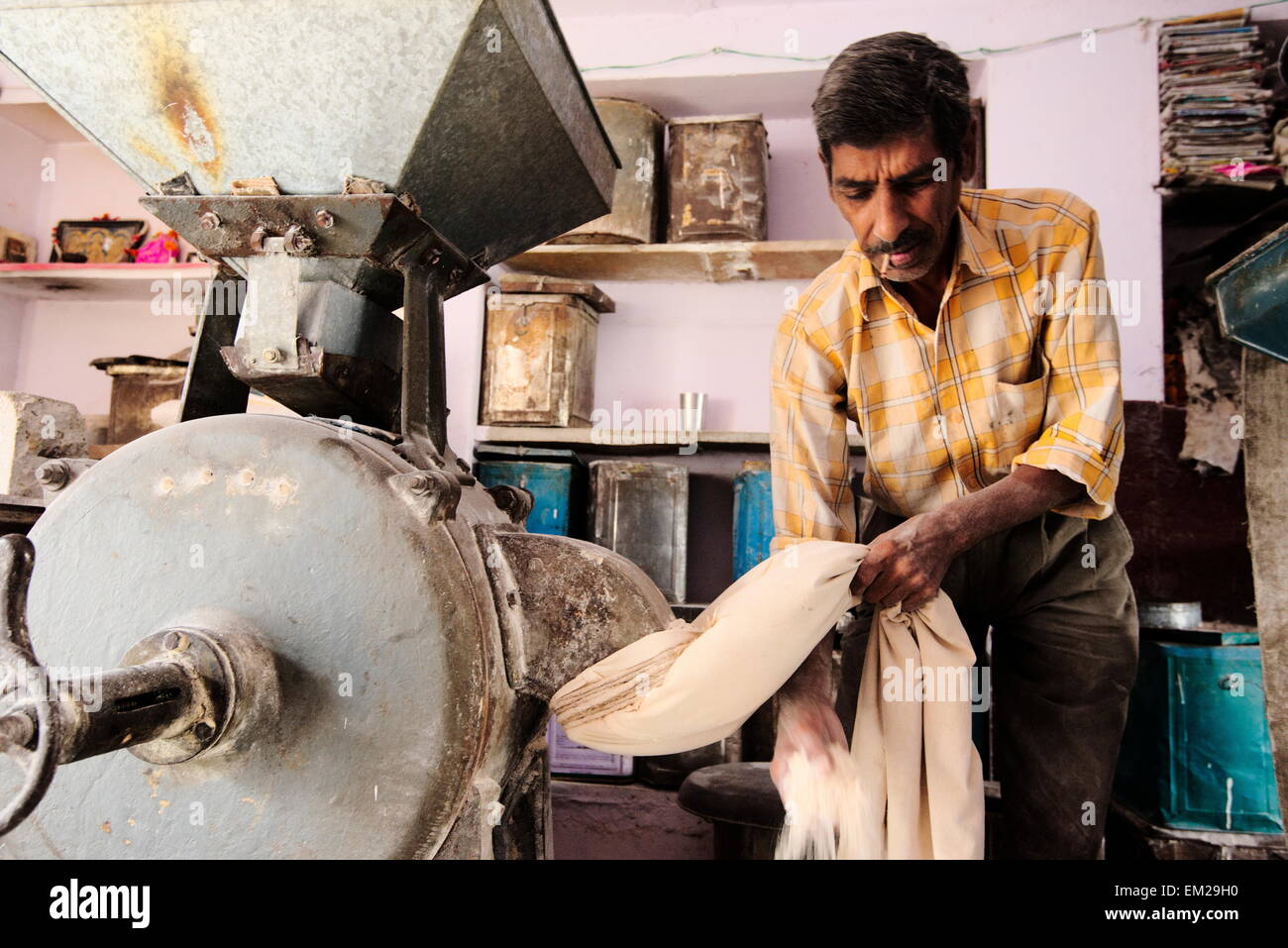 Miller working at a small mill inside Udaipur old town Stock Photo - Alamy