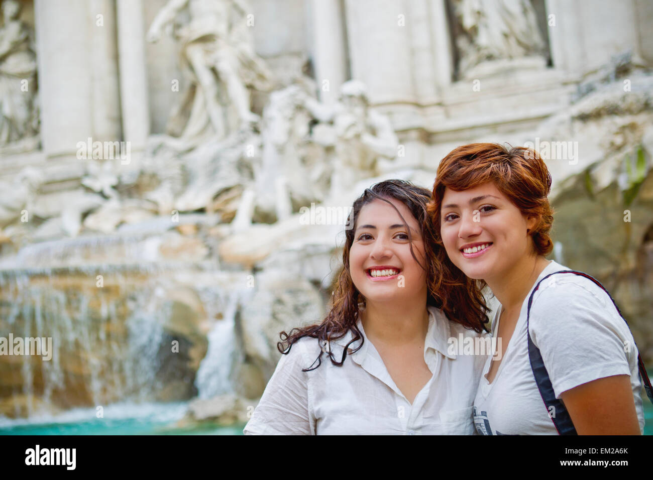 Two Friends Posing In Front Of Trevi Fountain; Rome Italy Stock Photo ...
