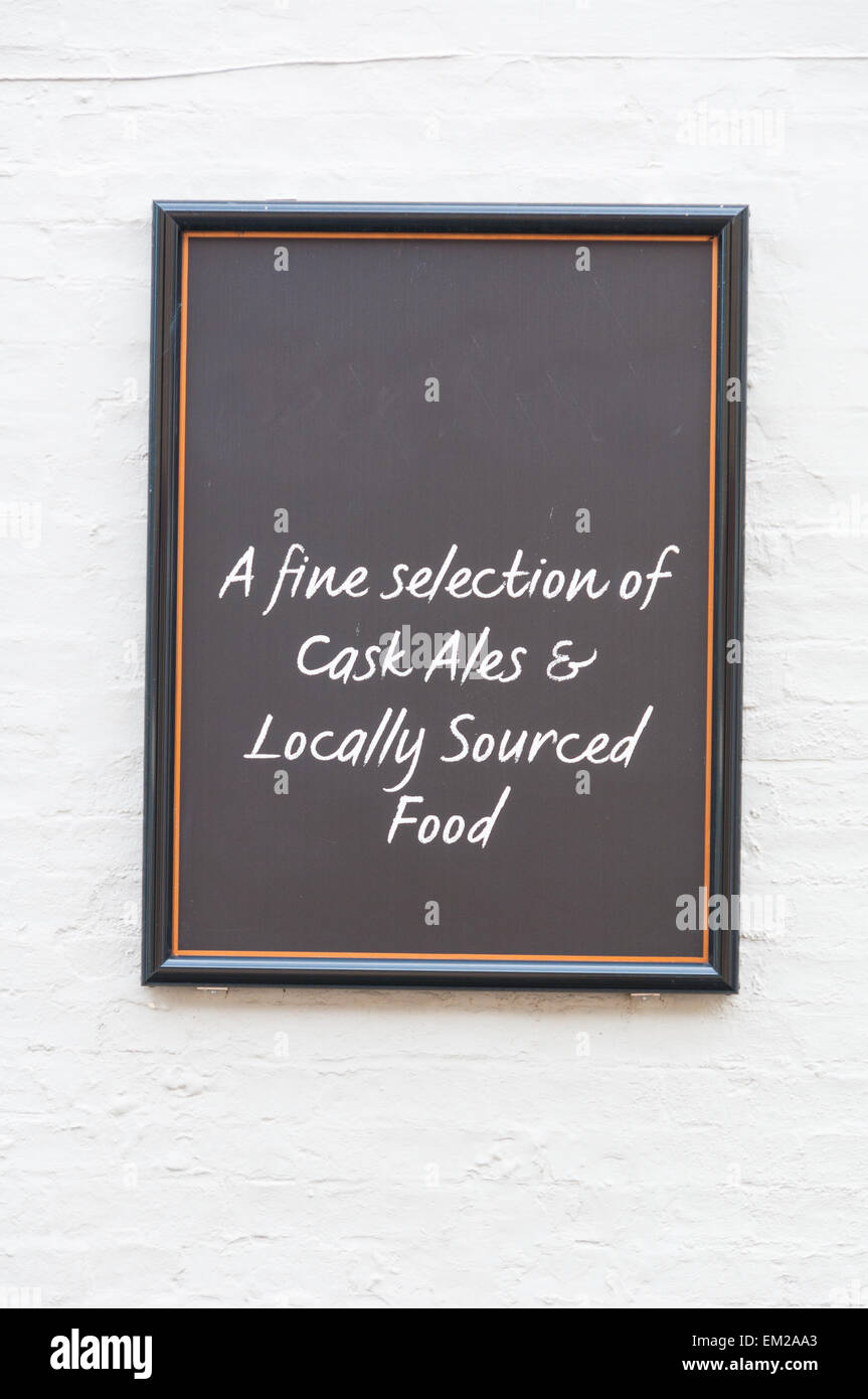 Isolated noticeboard for a pub on a white painted brick wall Stock ...