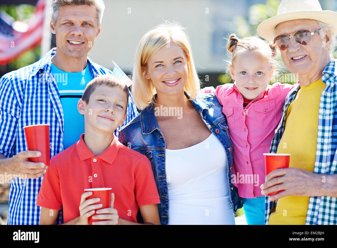 Happy senior man with his children and grandchildren looking at camera ...