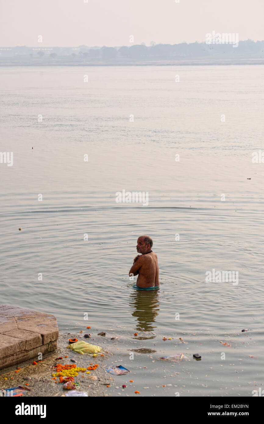 Bathers in the Ganges early in the morning at one of the ghats of ...