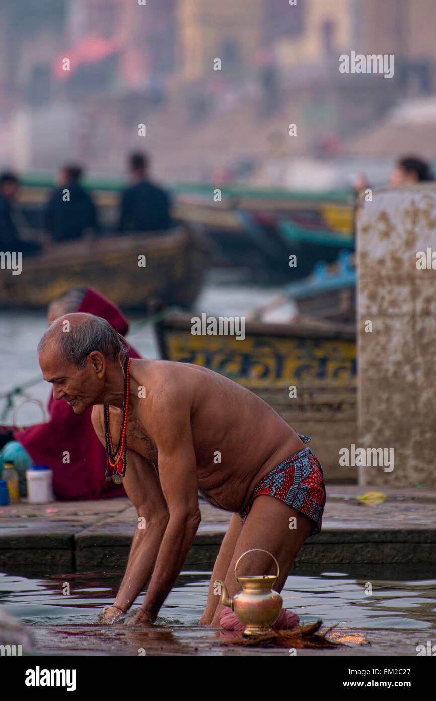 Bathers in the Ganges early in the morning at one of the ghats of ...