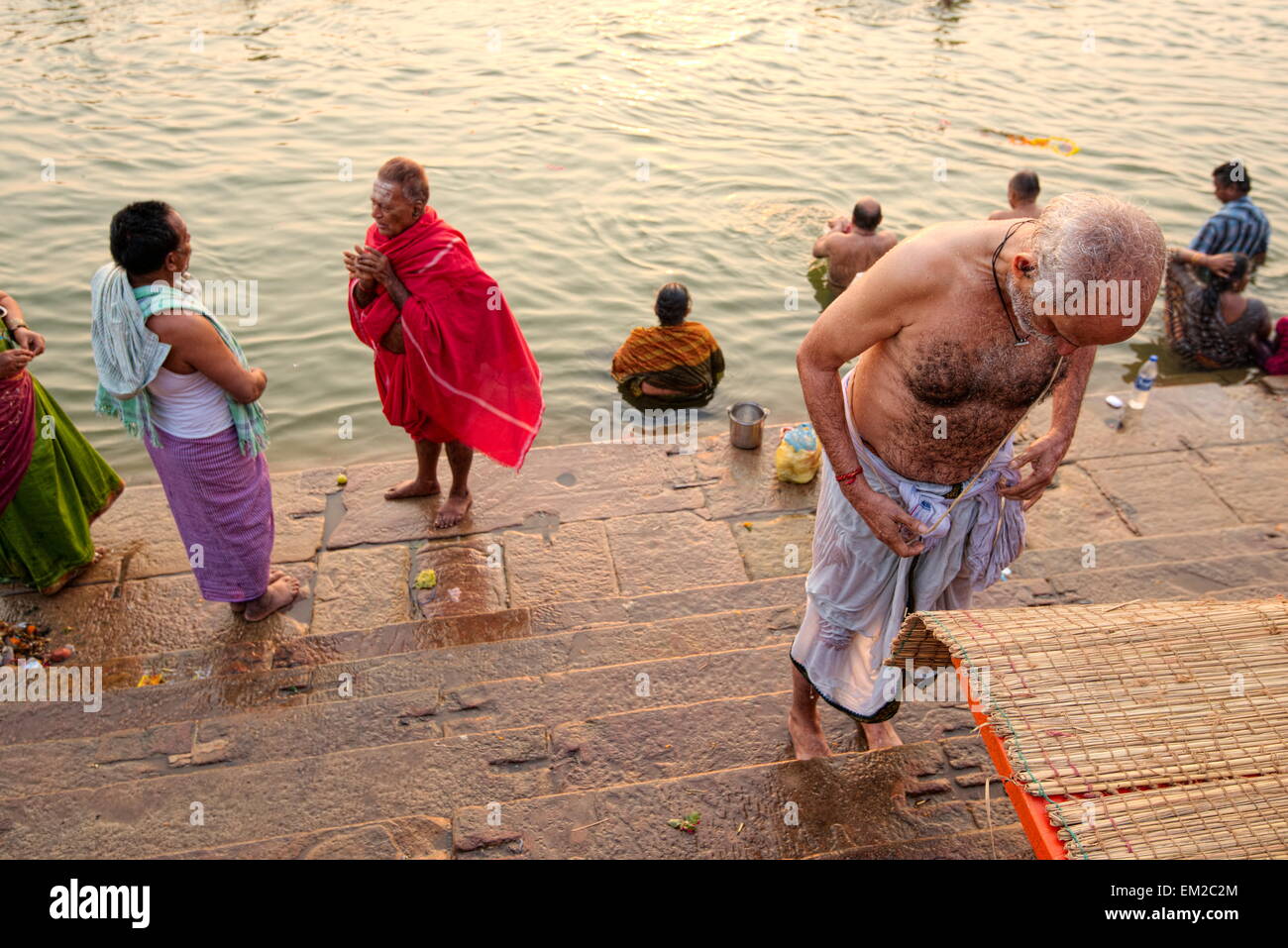Bathers in the Ganges early in the morning at one of the ghats of ...