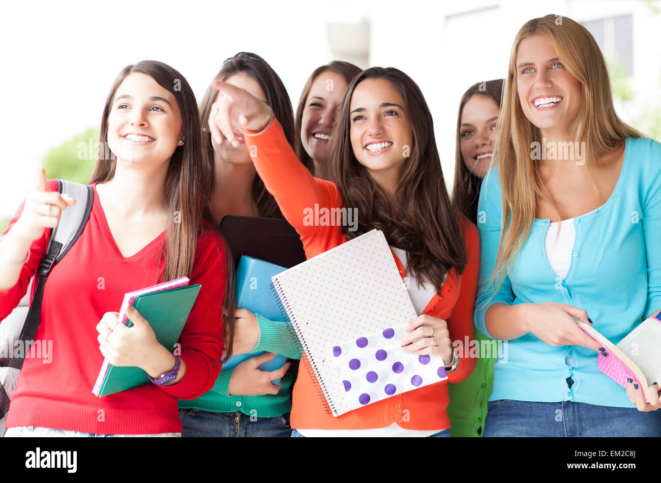 Smiling teenagers with exercise books Stock Photo - Alamy