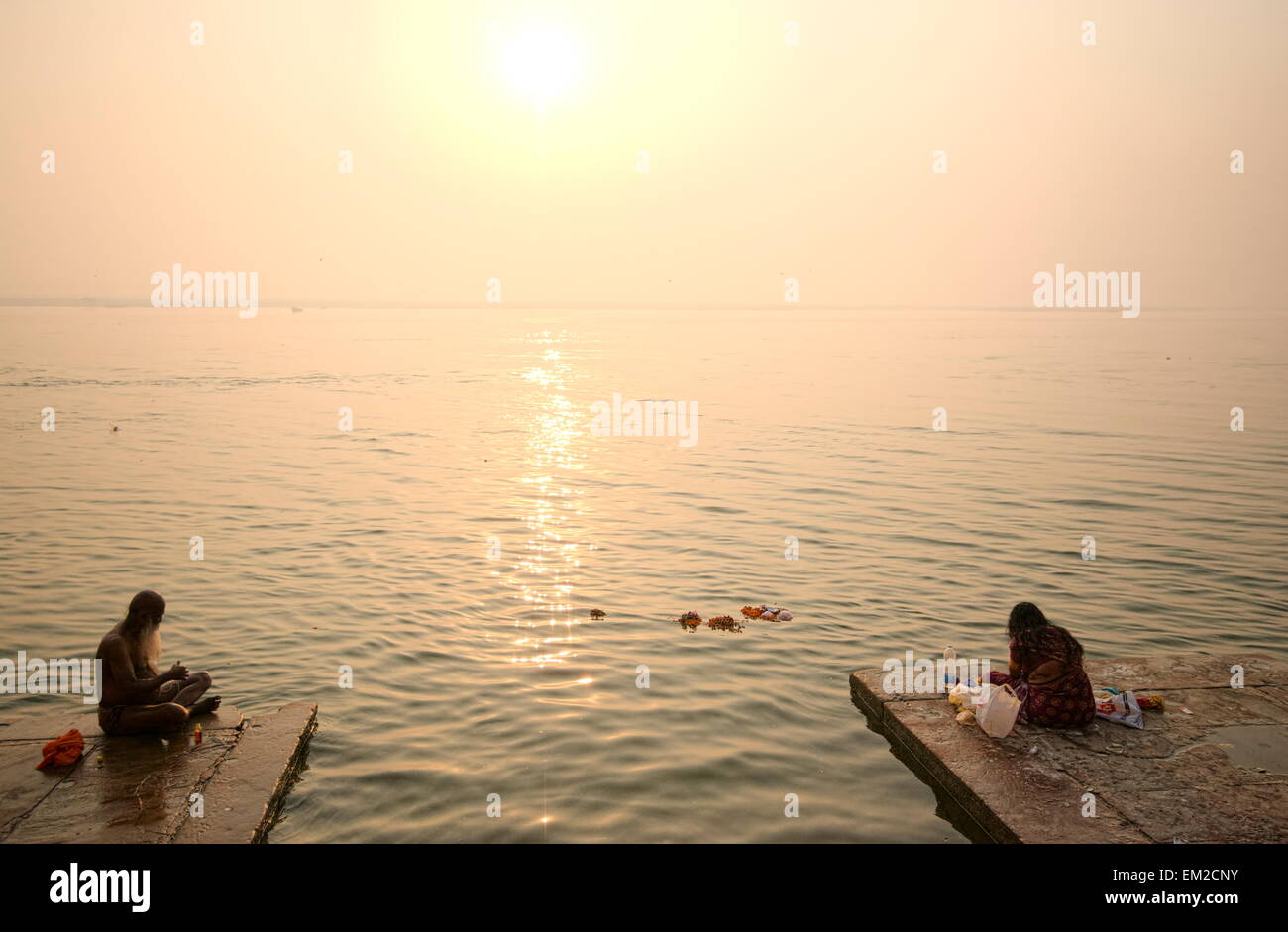 Bathers in the Ganges early in the morning at one of the ghats of ...