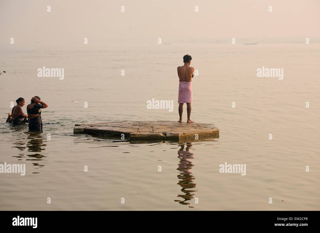Bathers in the Ganges early in the morning at one of the ghats of ...