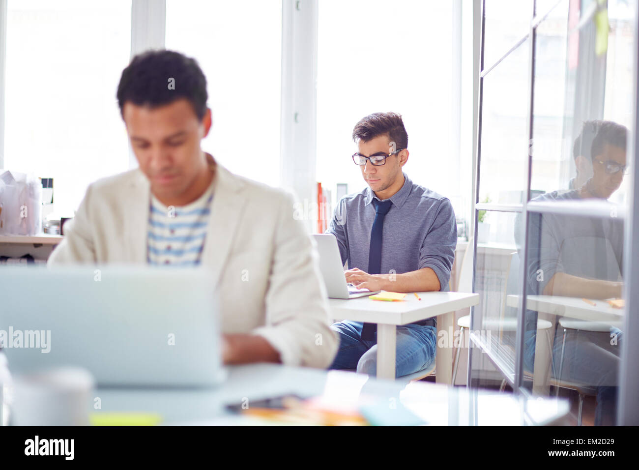 Male employee networking in office Stock Photo - Alamy