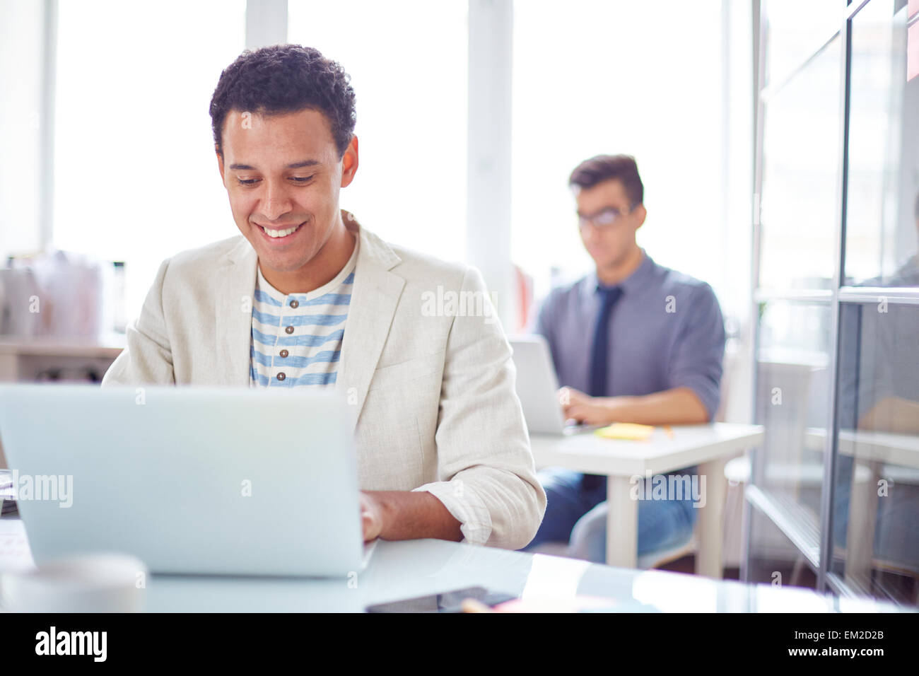 Young businessman typing at workplace Stock Photo - Alamy