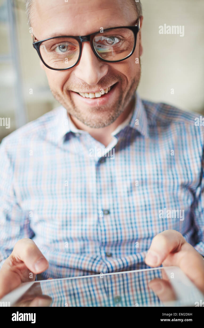 Smiling man with touchpad looking at camera Stock Photo - Alamy