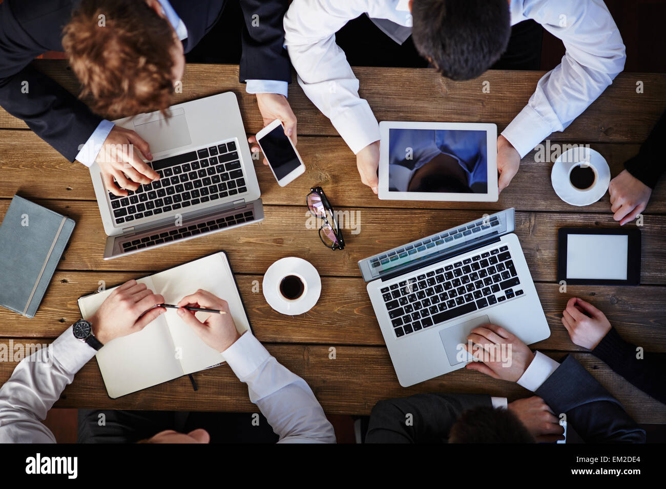 Group of business people using modern gadgets at workplace Stock Photo ... Group of business people using modern gadgets at workplace Stock Photo ...