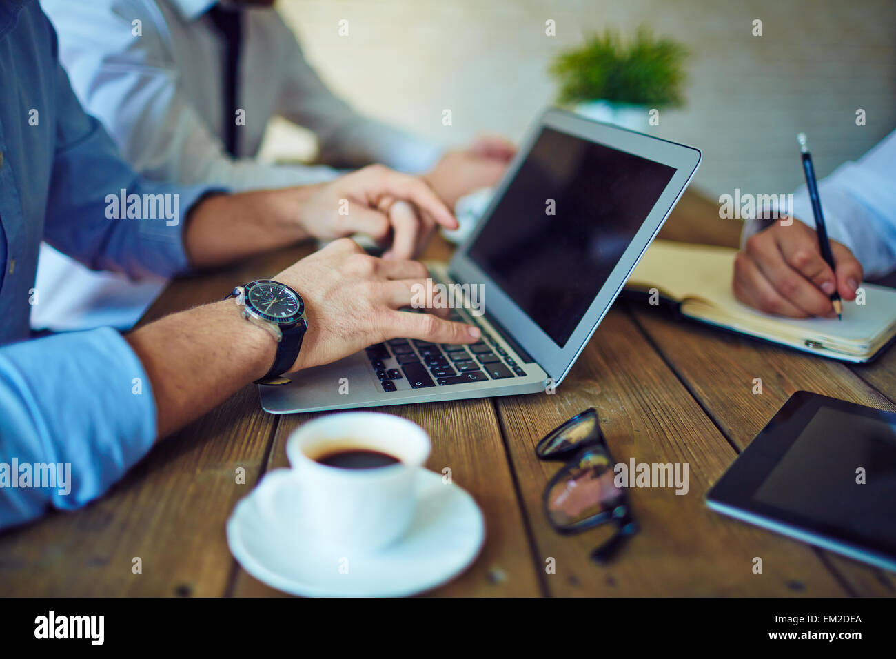 Male hands typing on laptop keypad in working environment Stock Photo ...
