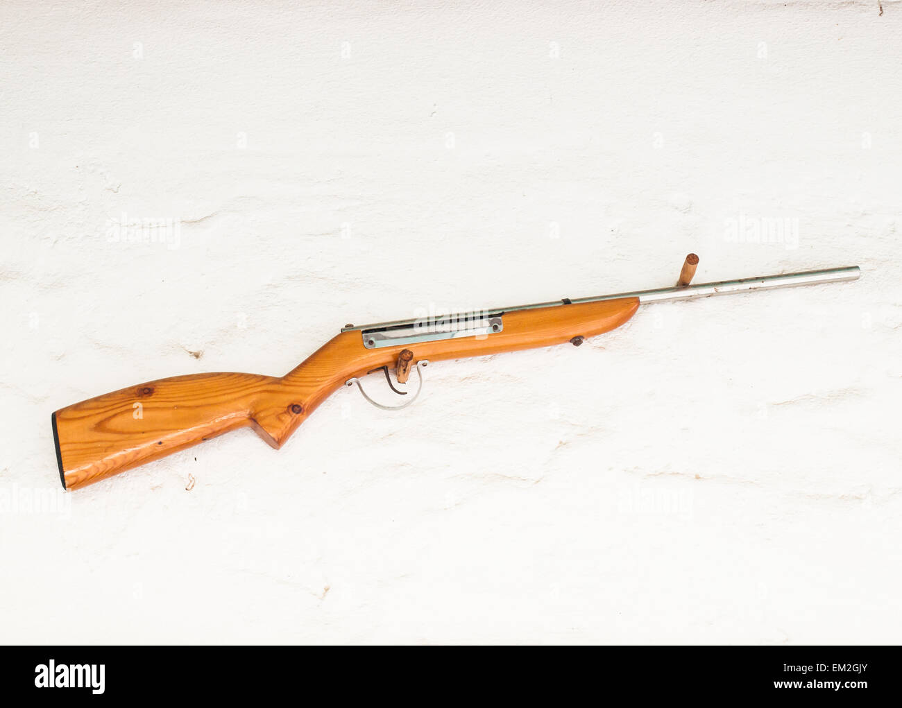 vintage old western wooden rifle hanged on white wall Stock Photo - Alamy