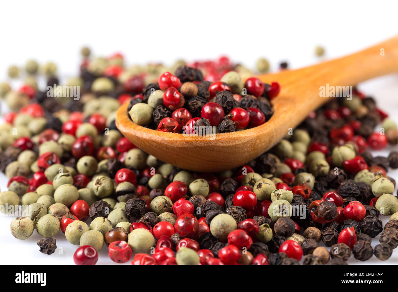 Pepper seasoning mix in wooden spoon isolated on white background ...