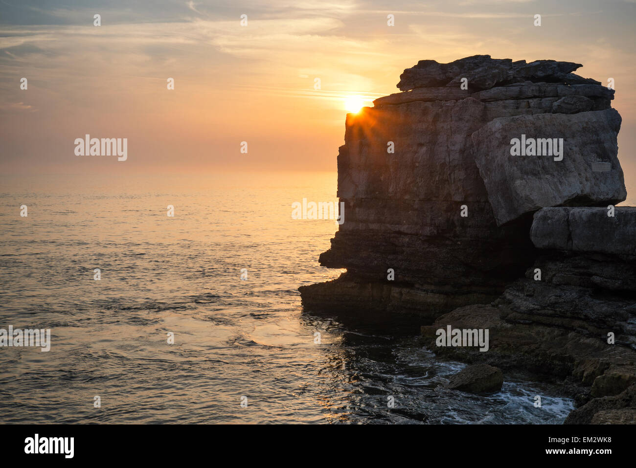 Rocky cliff landscape with sunset over ocean Stock Photo - Alamy