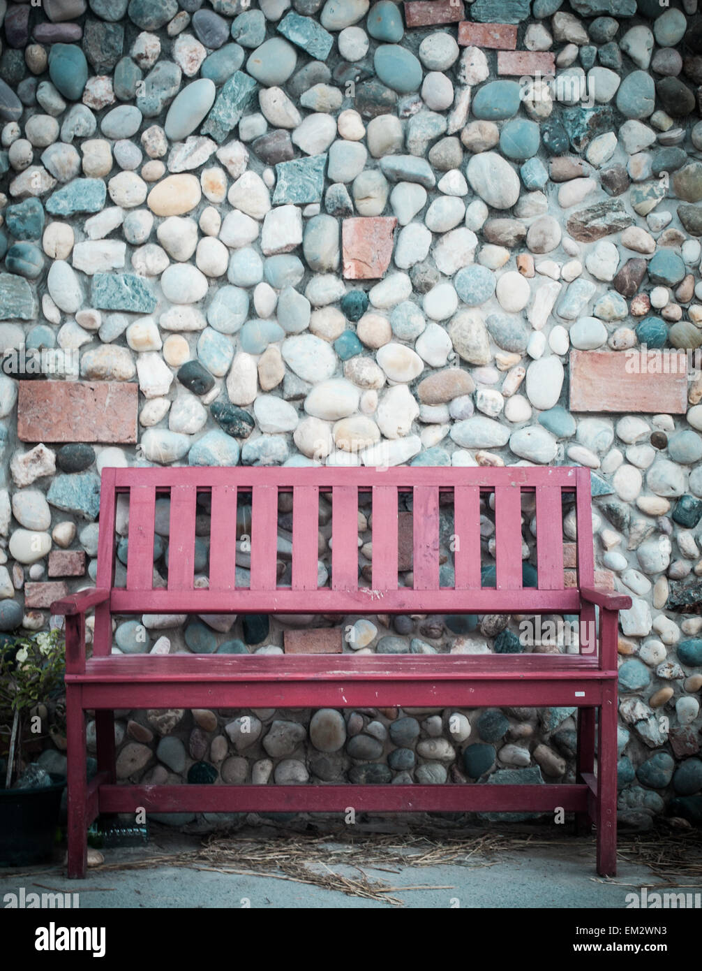 red wooden bench and stone wall background in retro style Stock Photo ...