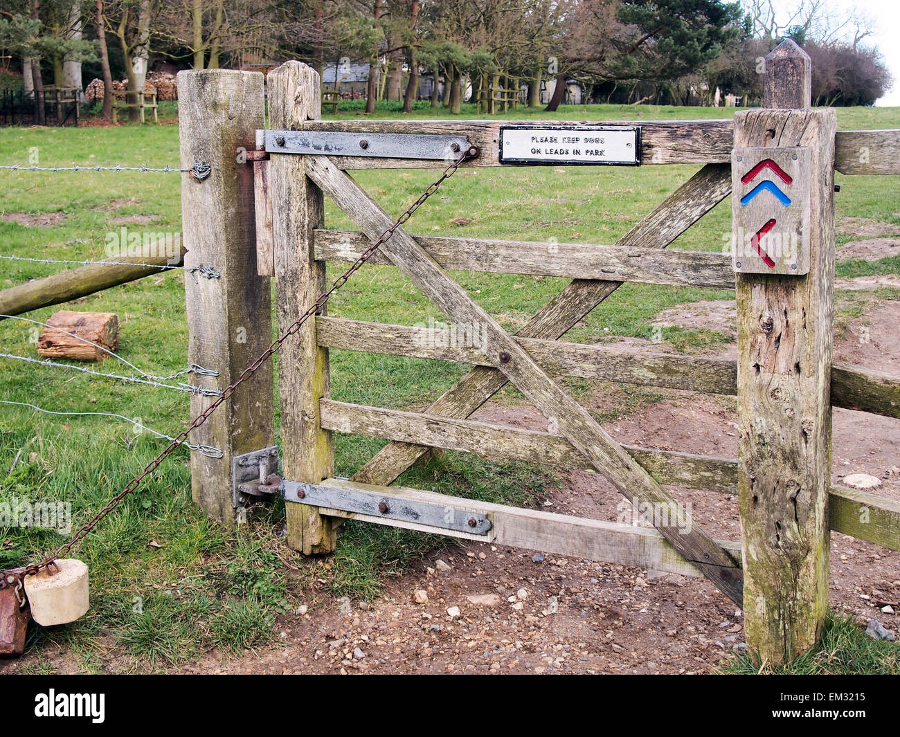 Wooden gate on a footpath with a rustic clsing device made from chain ...