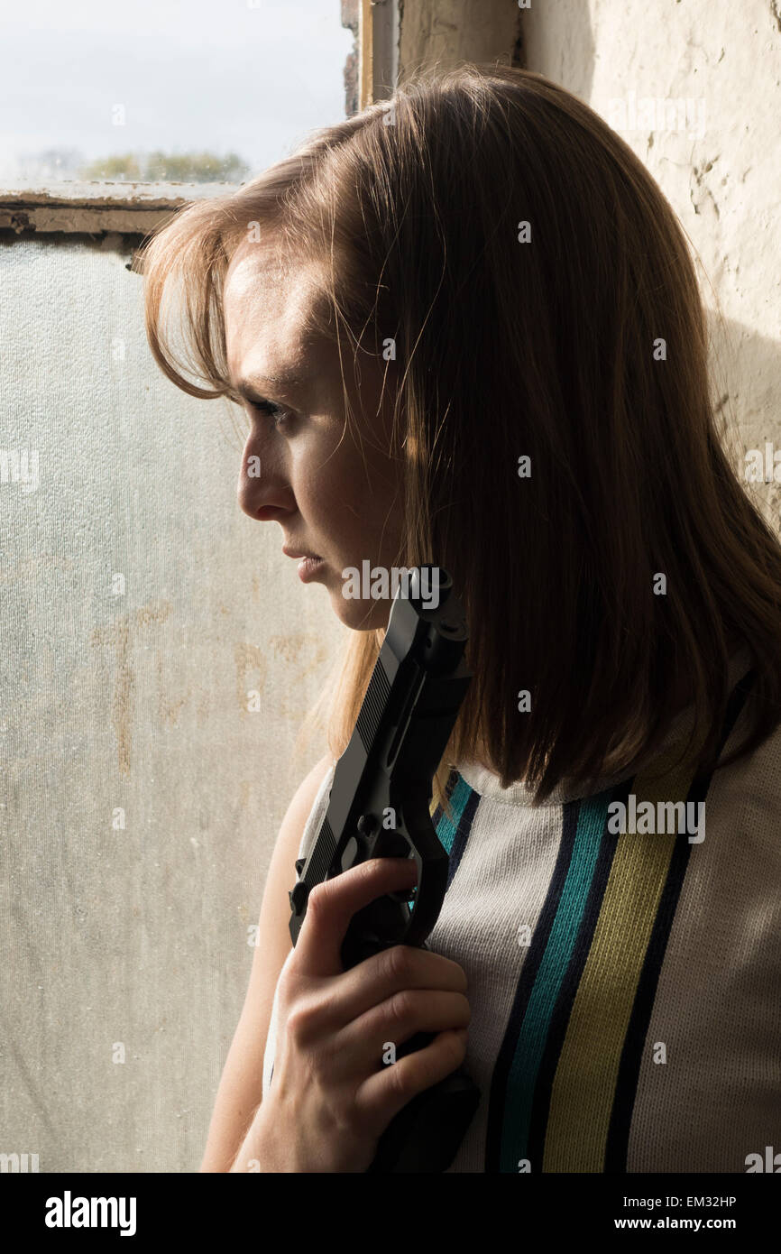 Woman with a gun Stock Photo - Alamy