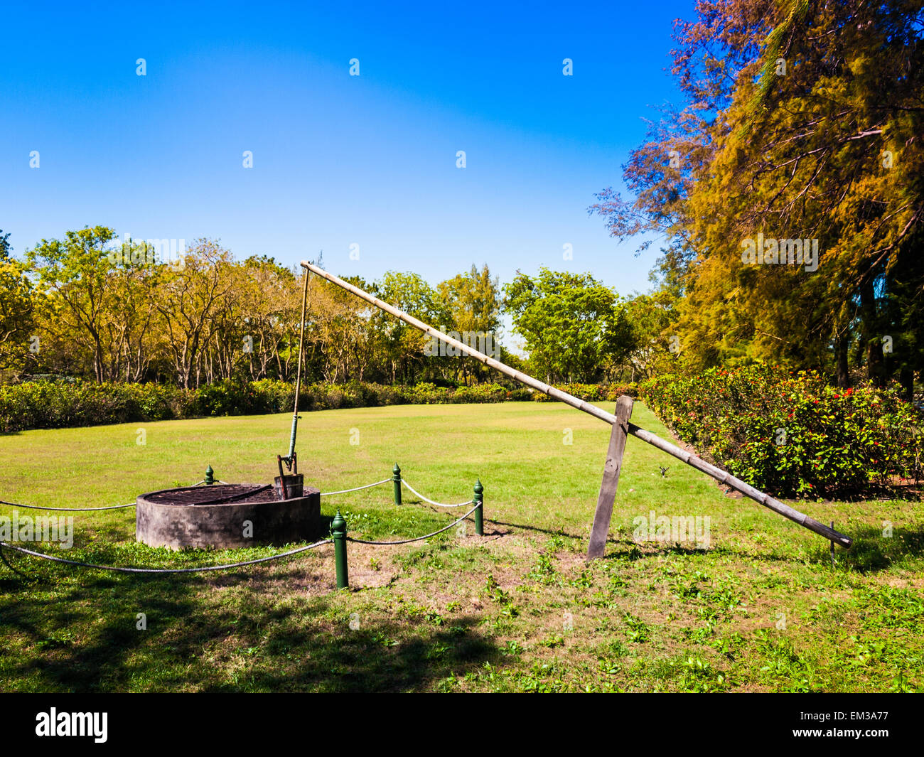 well on grass field in sunny day in vintage style Stock Photo - Alamy