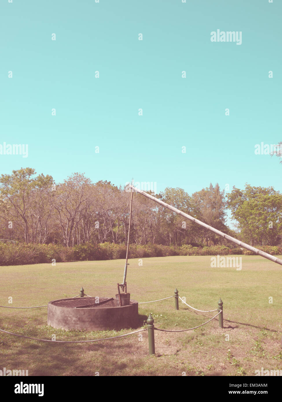 well on grass field in sunny day in vintage style Stock Photo - Alamy