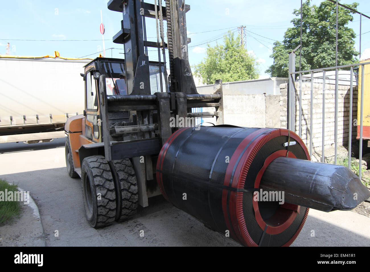 loader moves the roll of steel with the help of special equipment Stock ...