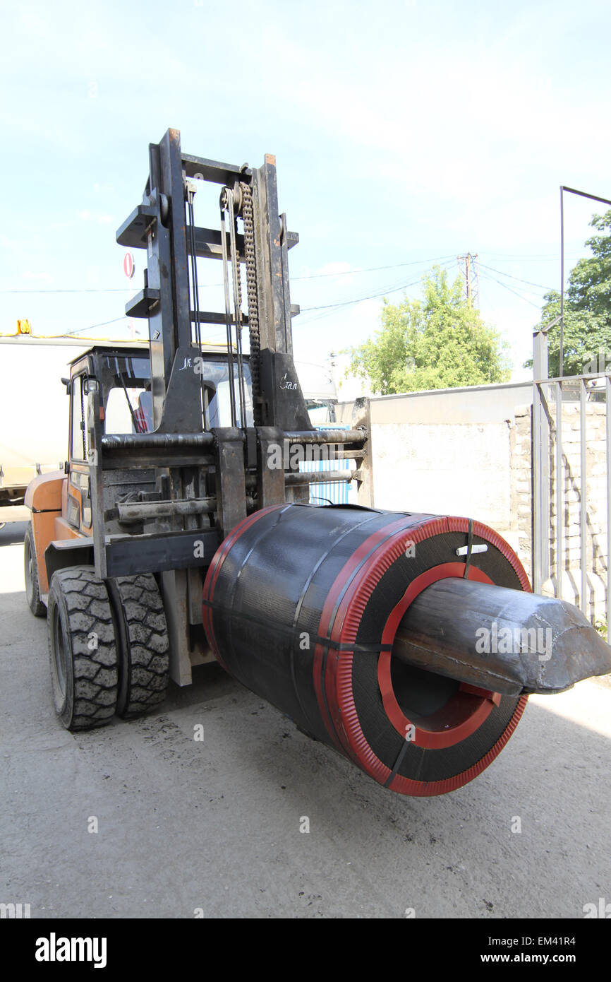 loader moves the roll of steel with the help of special equipment Stock ...