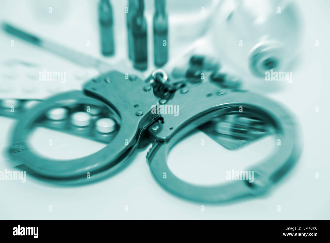 Handcuffs and medicine Stock Photo - Alamy