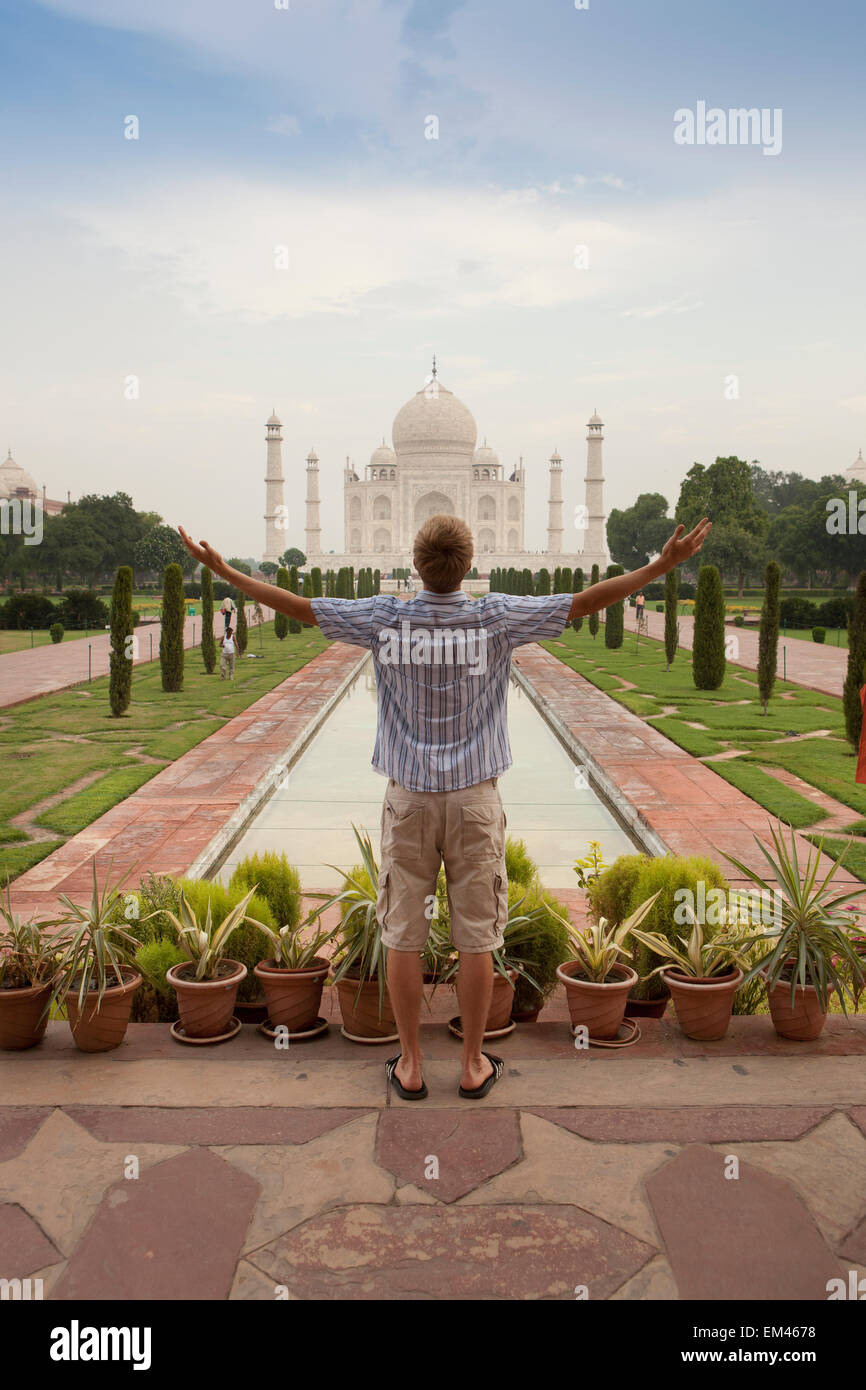 A Young Man With Arms Outstretched As He Looks At The Tah Mahal; Agra ...