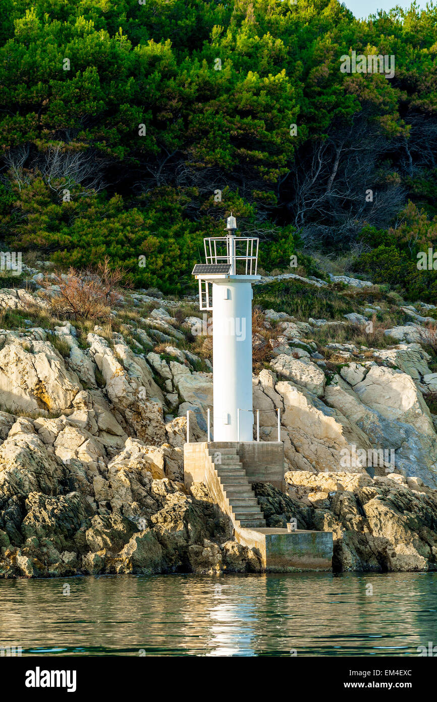 White navigation beacon on a coastline Stock Photo - Alamy