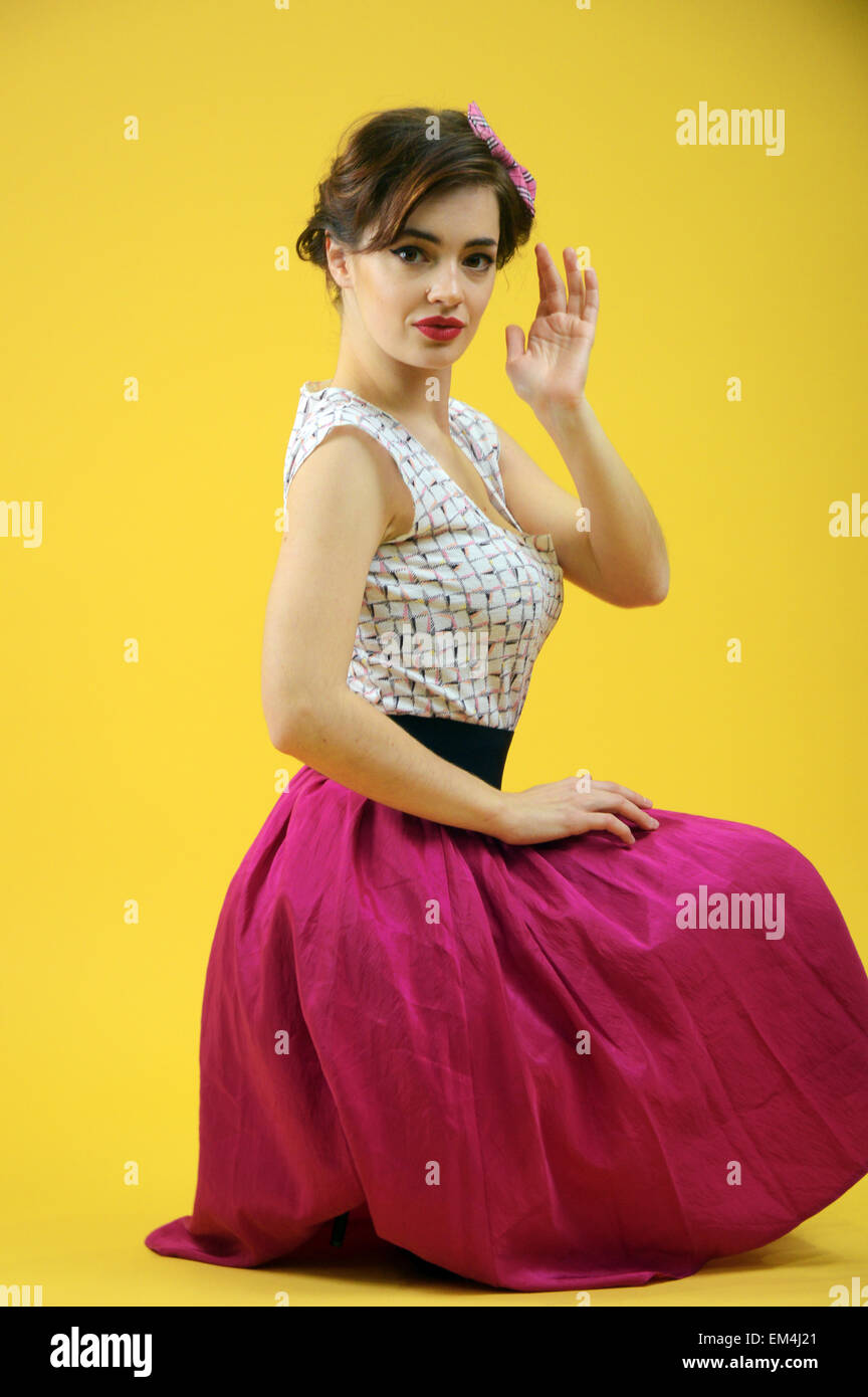 Photo Expo-2015. Moscow girl model posing on a yellow background Stock ...