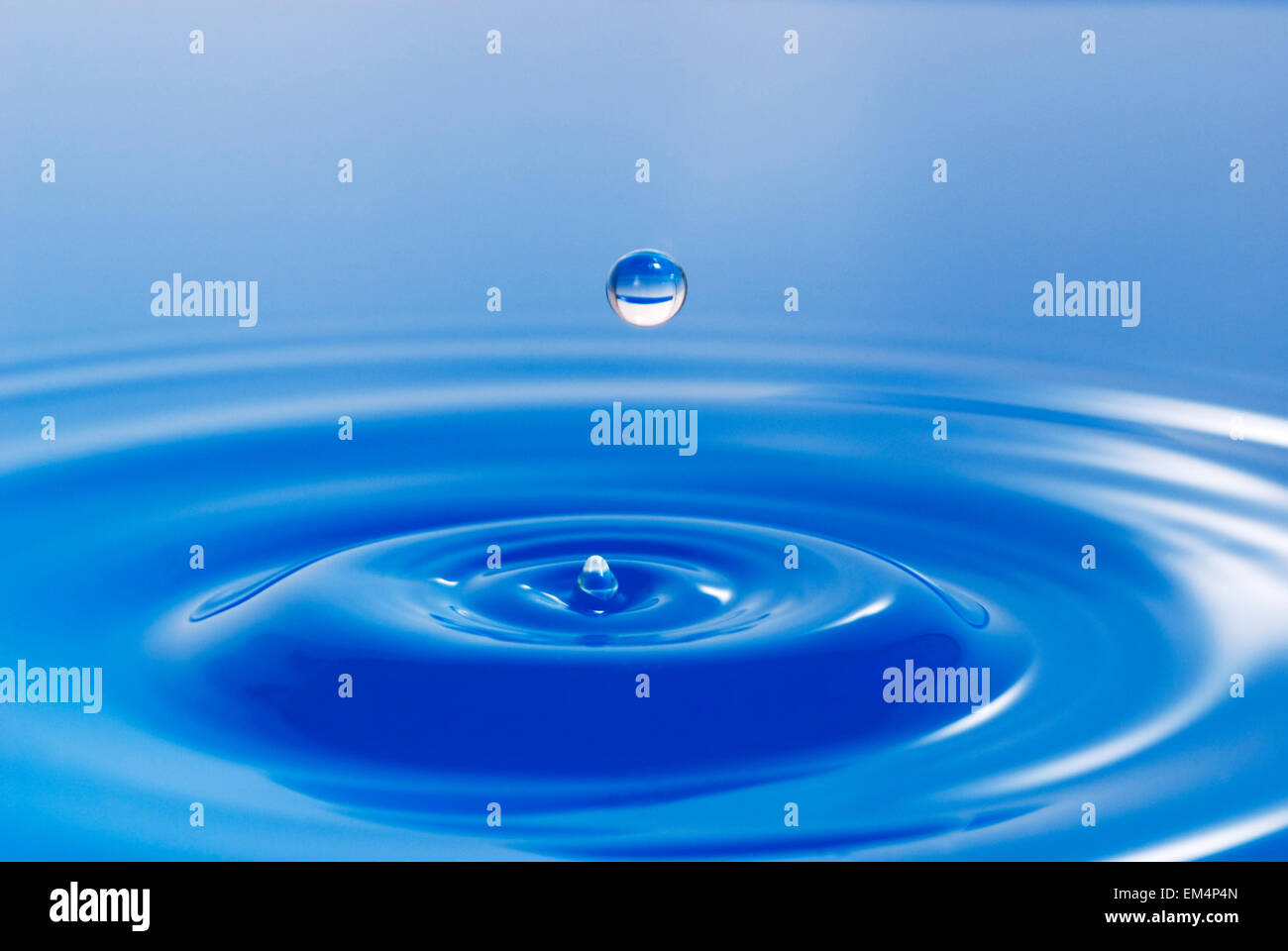 Blue water with jumping waterdrop Stock Photo - Alamy