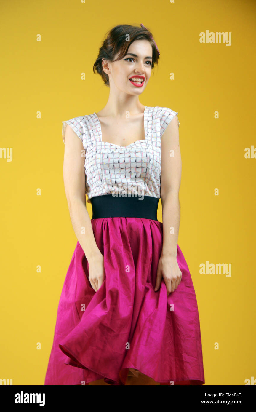 Photo Expo-2015. Moscow girl model posing on a yellow background Stock ...
