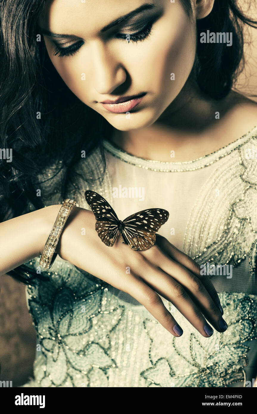 Beautiful young woman with a butterfly Stock Photo - Alamy