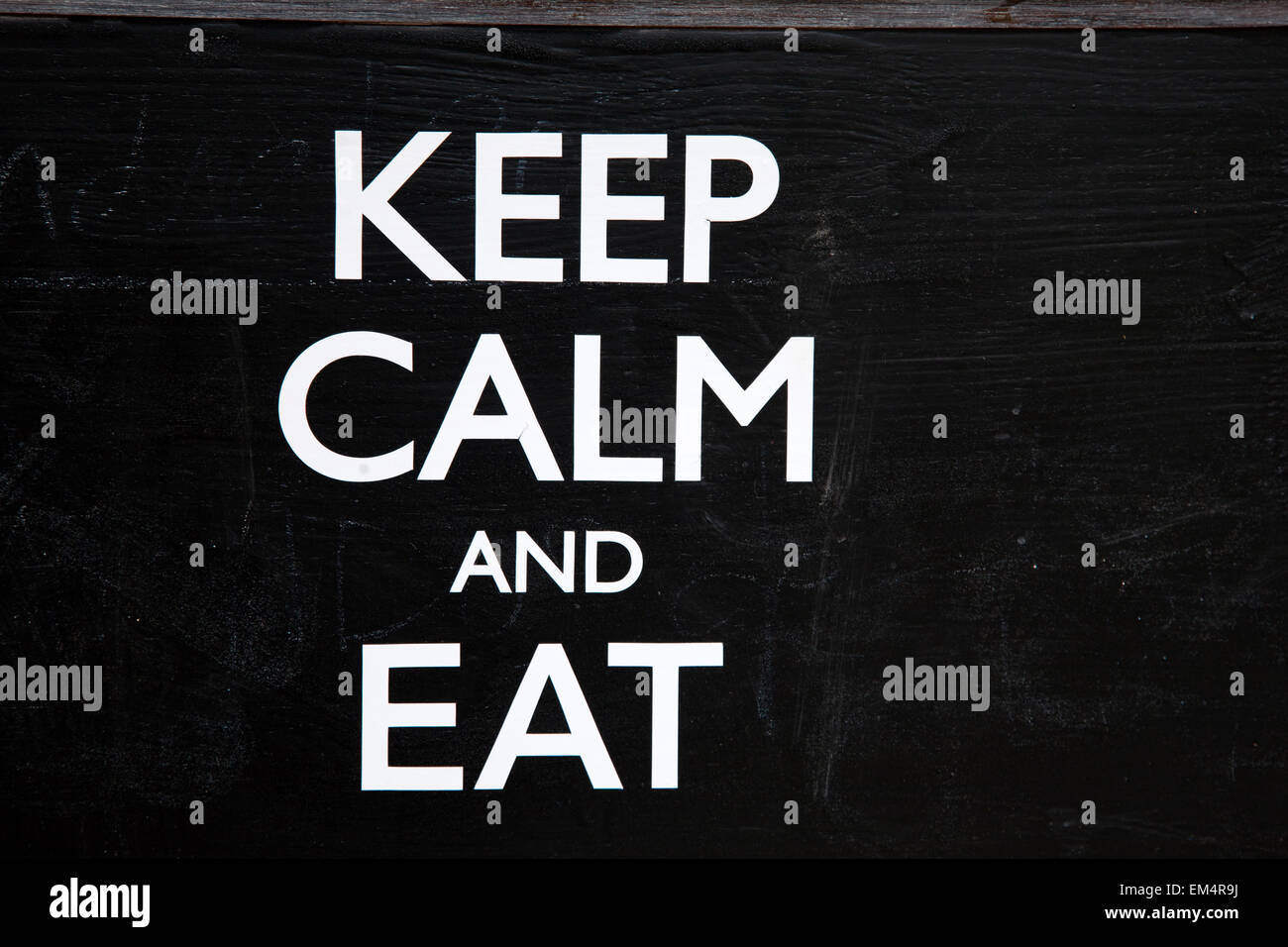Keep Calm and Eat Sign on Black Background Stock Photo - Alamy