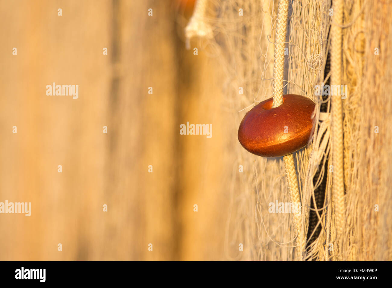Fishing net and its orange floating devices Stock Photo - Alamy