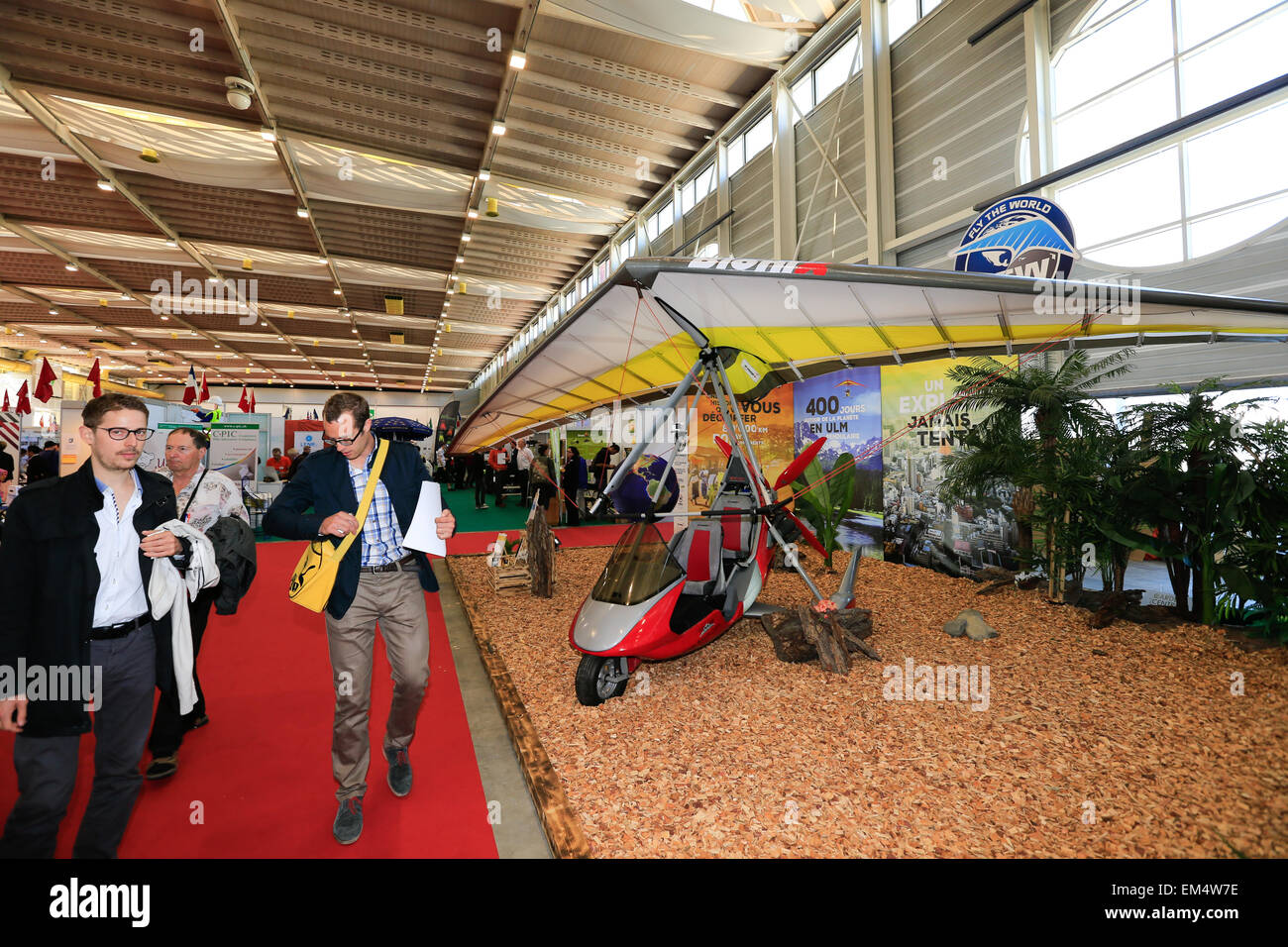 Geneva, Switzerland. 15th Apr, 2015. Visitors pass by a powered glider ...